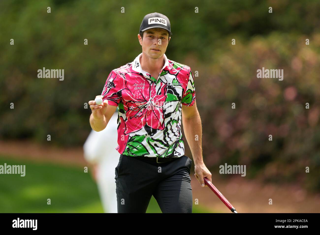 Viktor Hovland, of Norway, waves after his putt on the 13th hole during ...