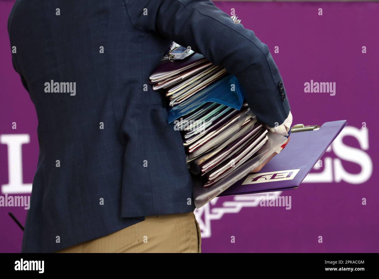23.02.2023, Qatar, , Doha - FEI official carrying horse passports under ...