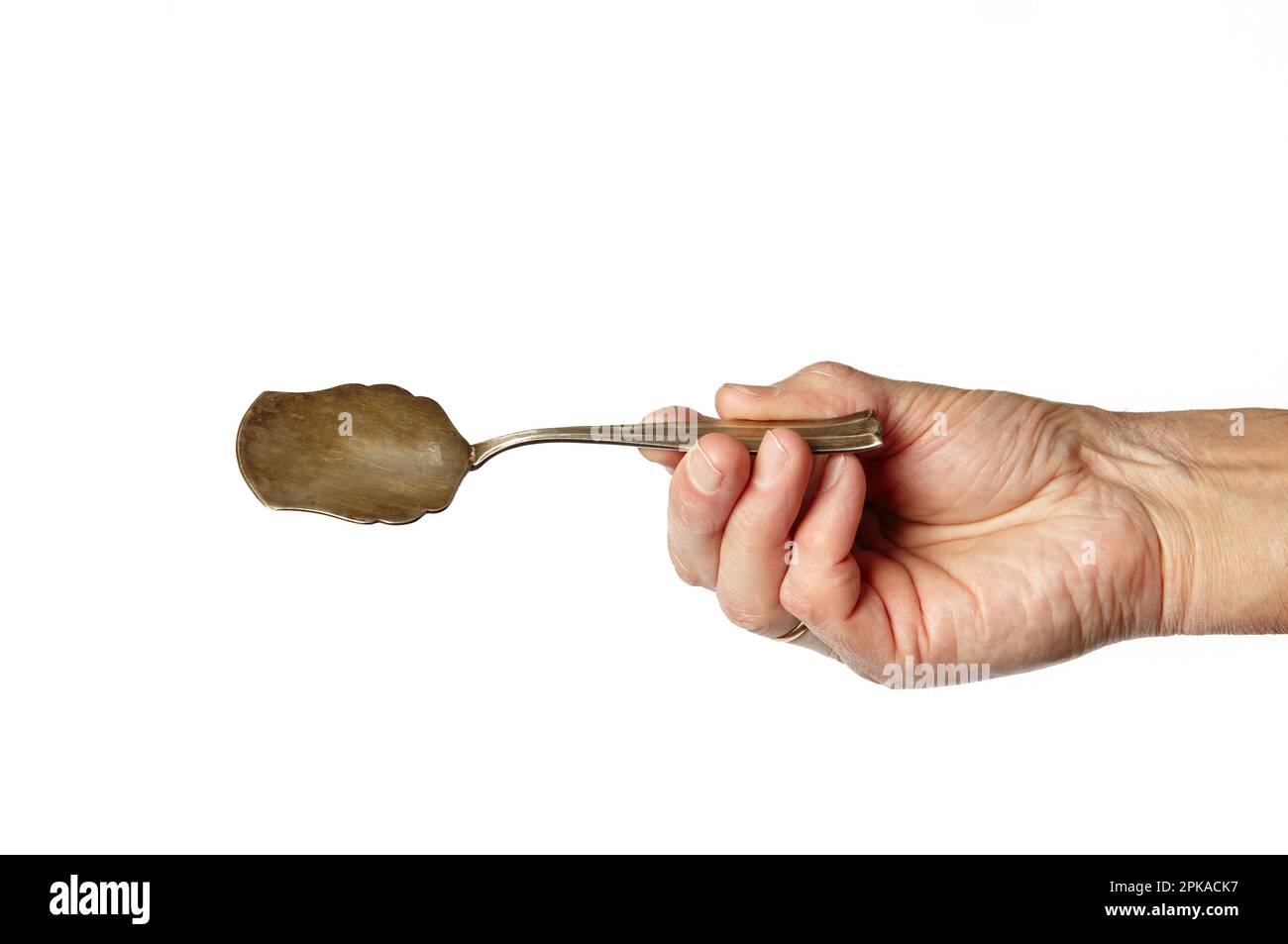 Men's hand holding cake spatula isolated on white background. Vintage ...
