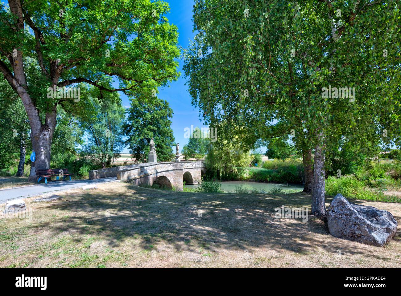 Three-arched stone bridge, Saale, river, station path, village view ...