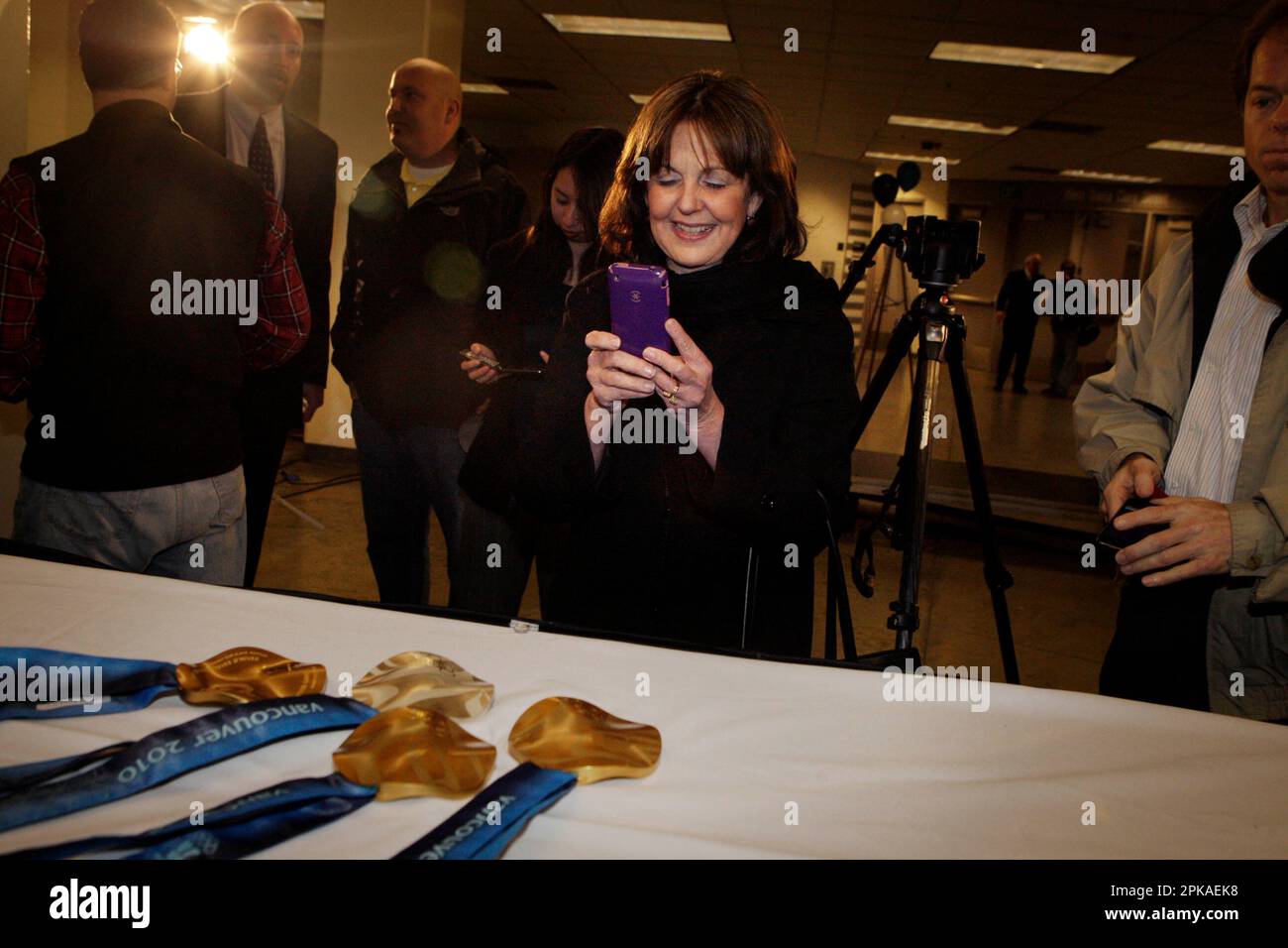 Cheryl Warner (center) of Monterey takes a photo of the 3 Olympic gold ...