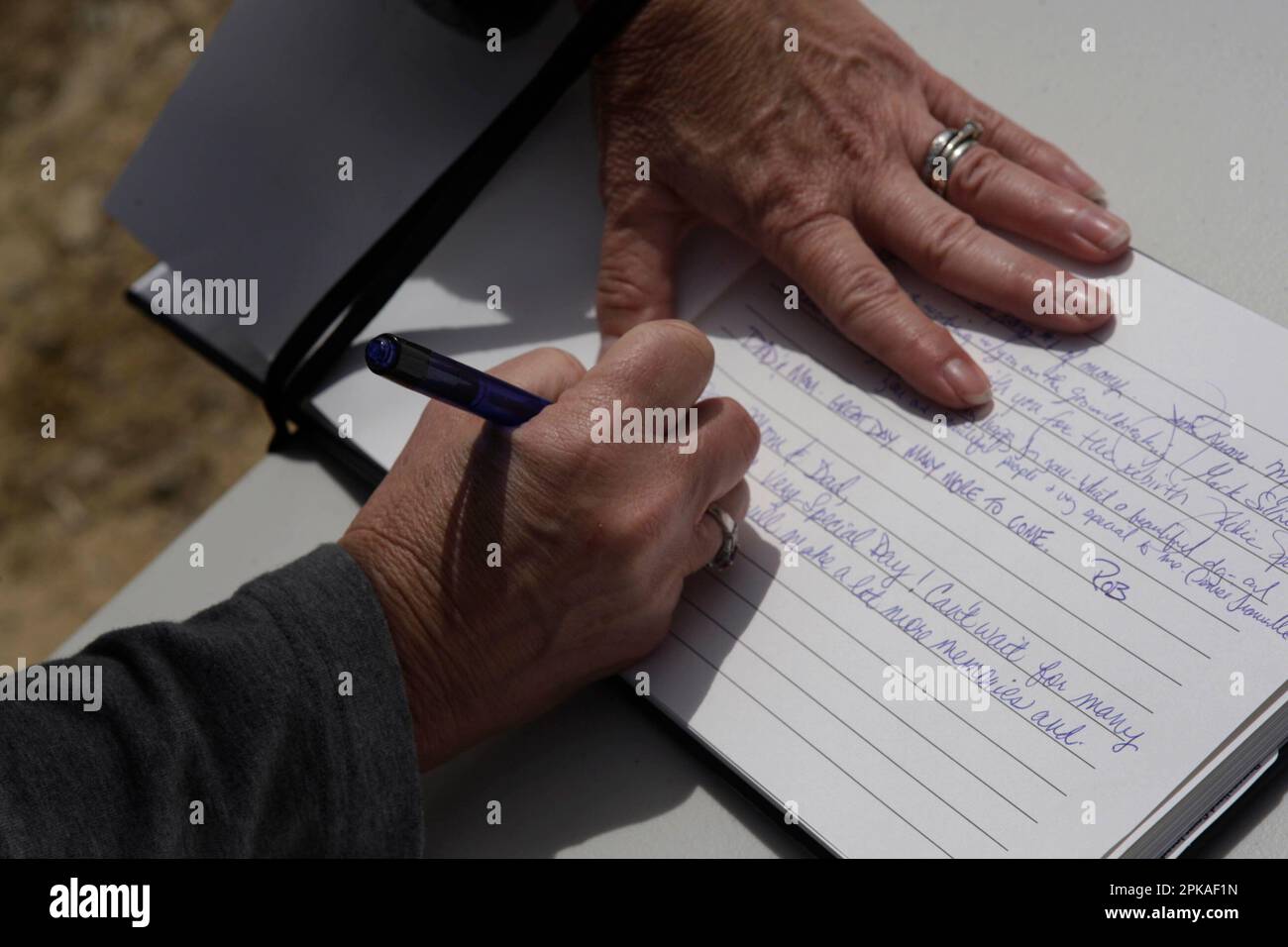 Cindy Talcott of San Mateo signs a guest book for her parents, Bob and ...