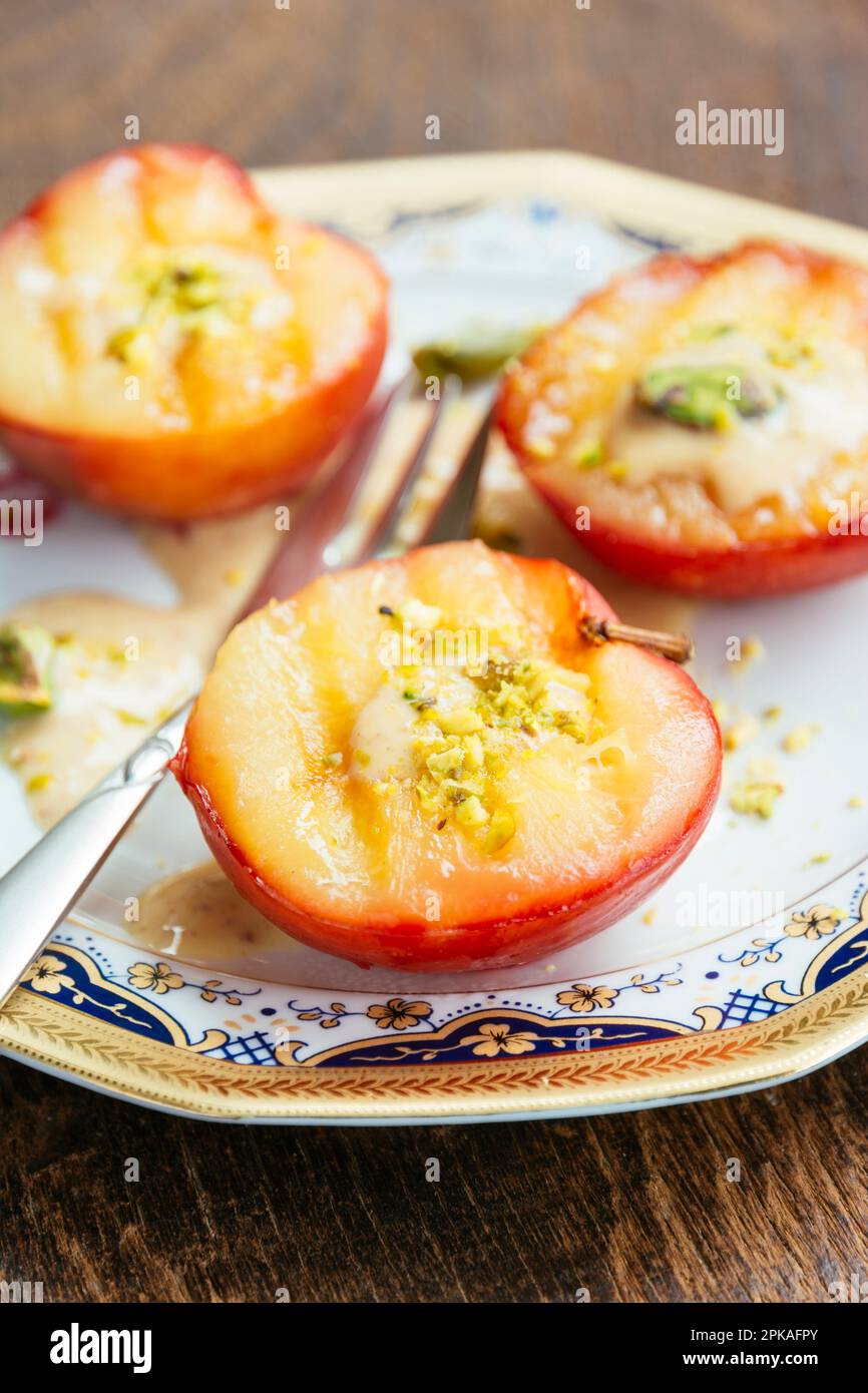 Grilled Plums with Maple Cinnamon Soy Yogurt and Pistachios Stock Photo ...