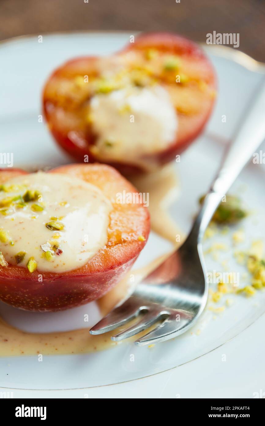Grilled Plums with Maple Cinnamon Soy Yogurt and Pistachios Stock Photo ...