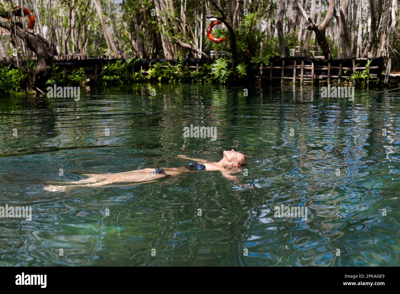 Pretty young caucasian female tourist swimming in El Corchito ...