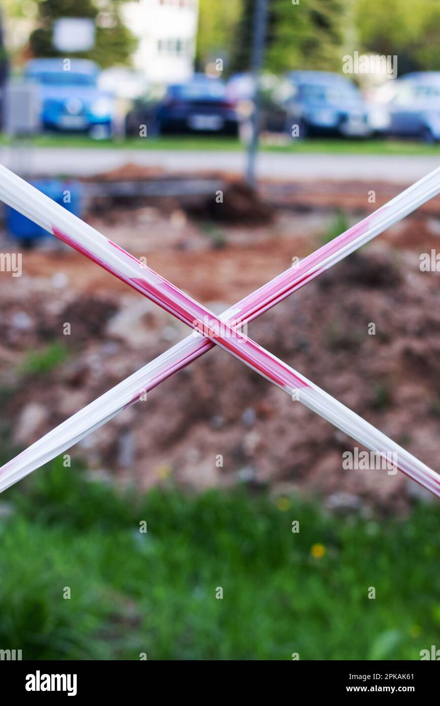 Construction tape cross at a construction site Stock Photo - Alamy