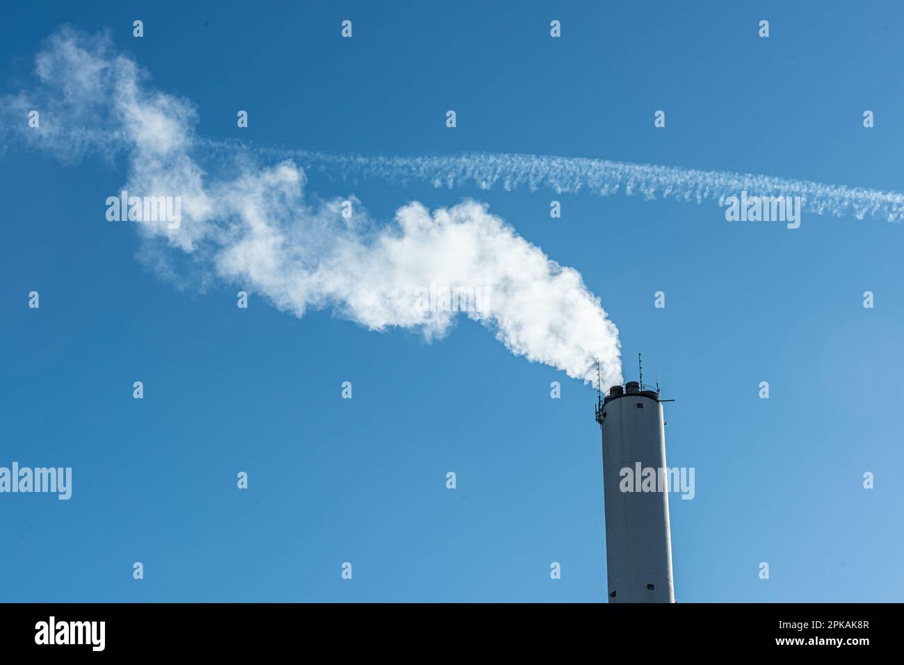 Steam rising from a tall chimney Stock Photo - Alamy