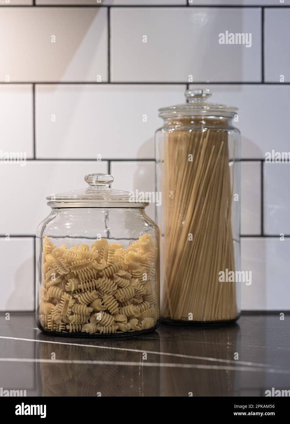 Pasta in glass recepticles in a kitchen Stock Photo - Alamy