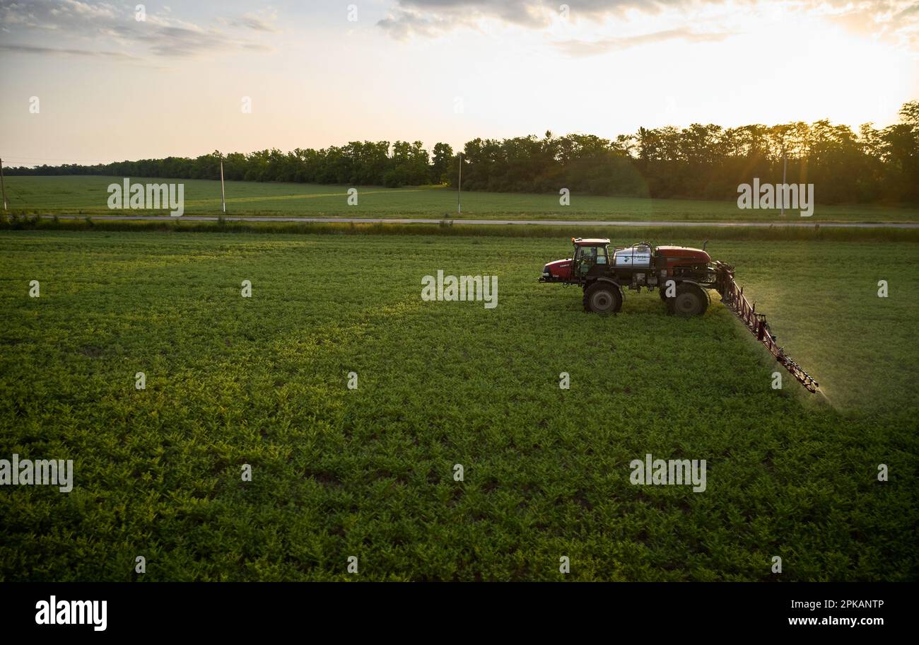 Tractor spraying insecticide fungicide on hi-res stock photography and ...