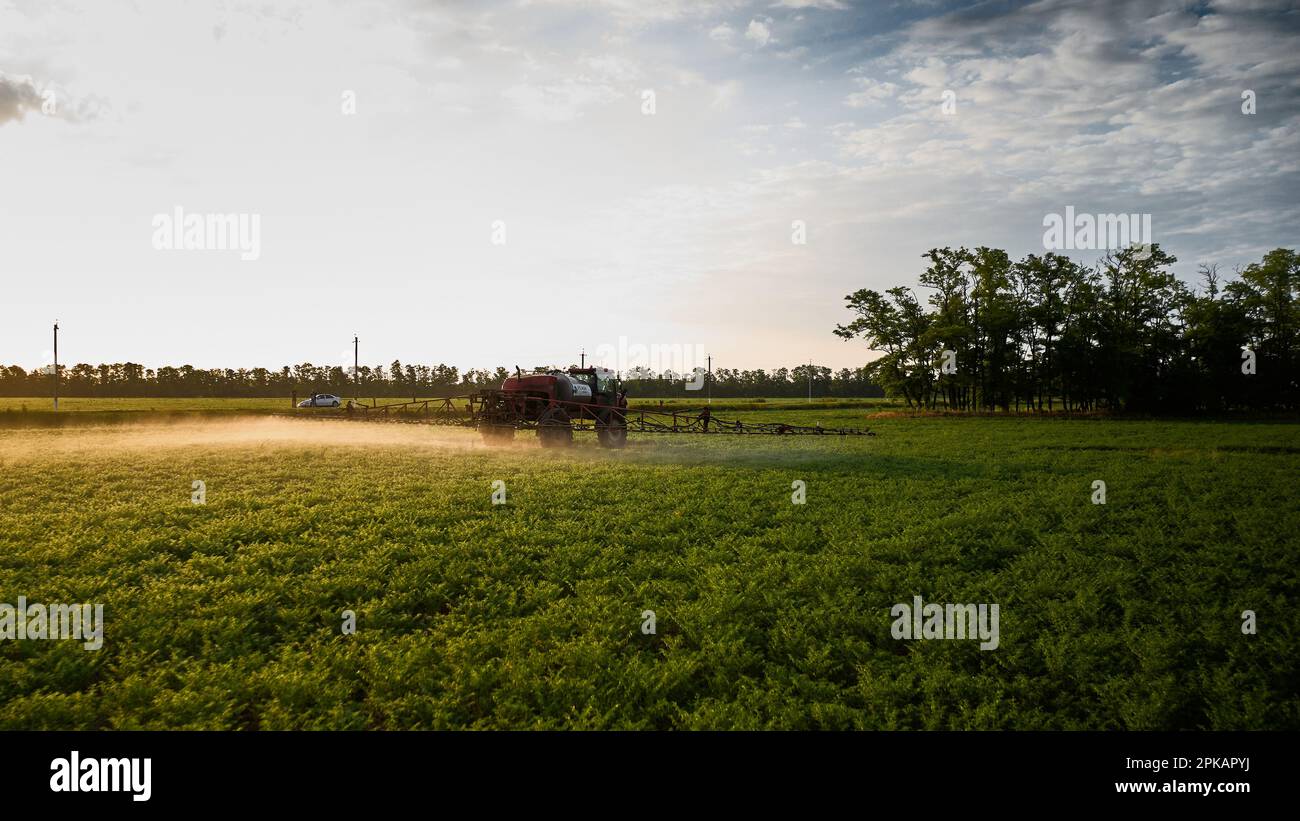 Sprayer CASE 3330 spraying pesticides on chickpea field. Field ...