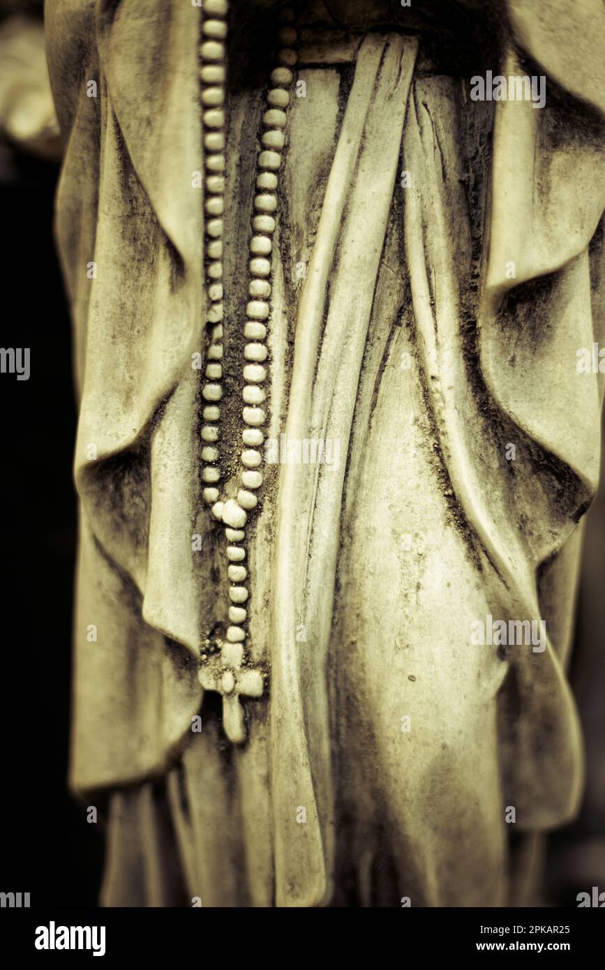 Close-up of Christian statue with prayer chain Stock Photo - Alamy