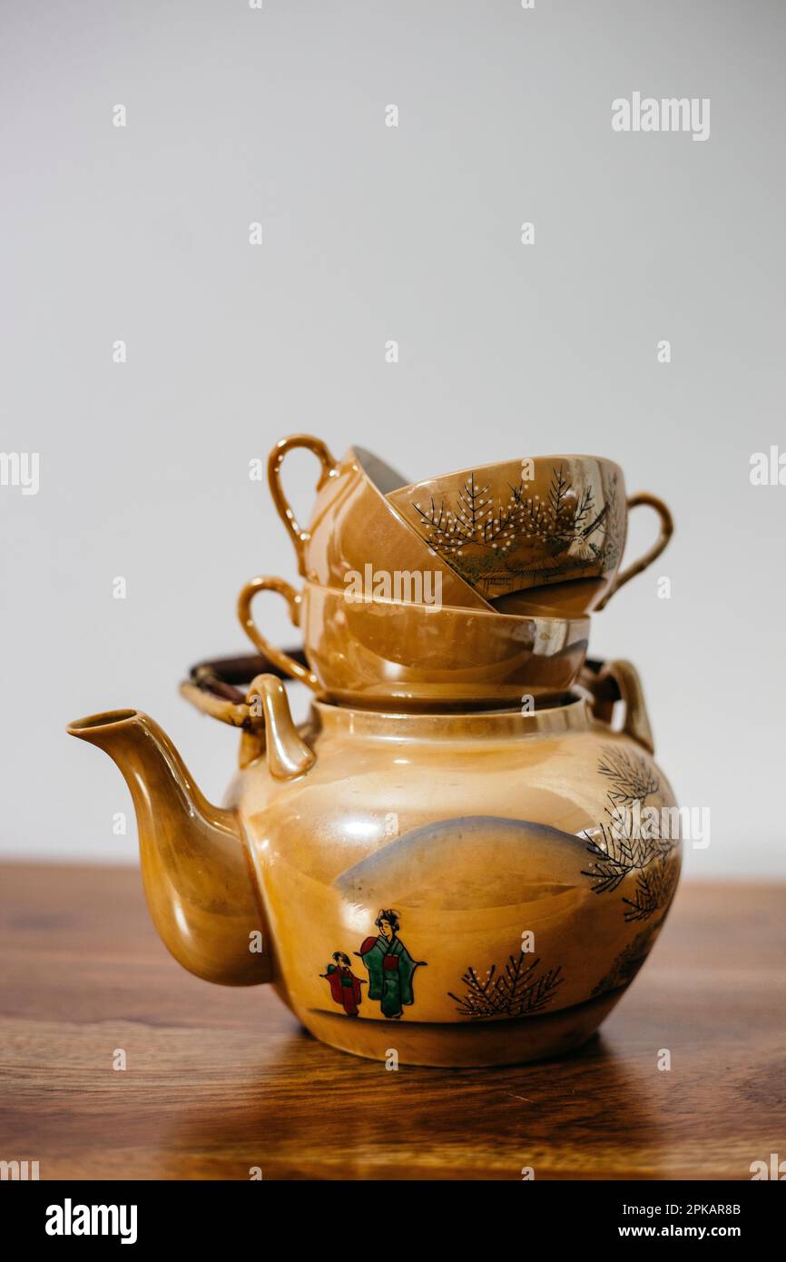 Three tea cups stacked on a japanese teapot hi-res stock photography ...