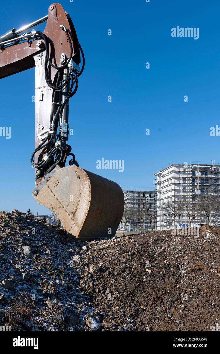 Shovel of brown excavator stands on large construction site with multi ...