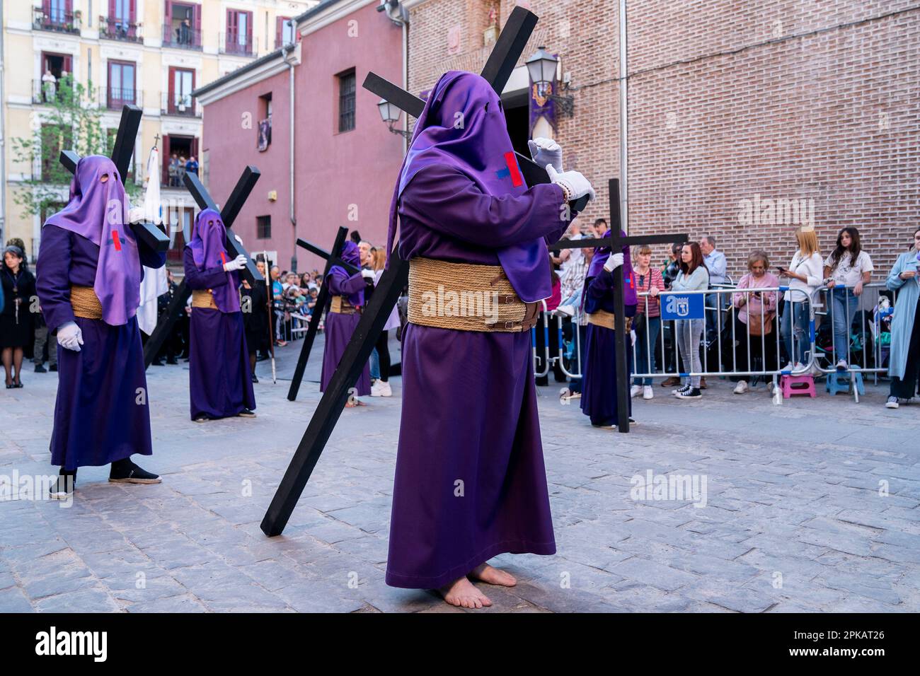 Penitents carry wooden crosses in the procession of Jesus the Poor and ...