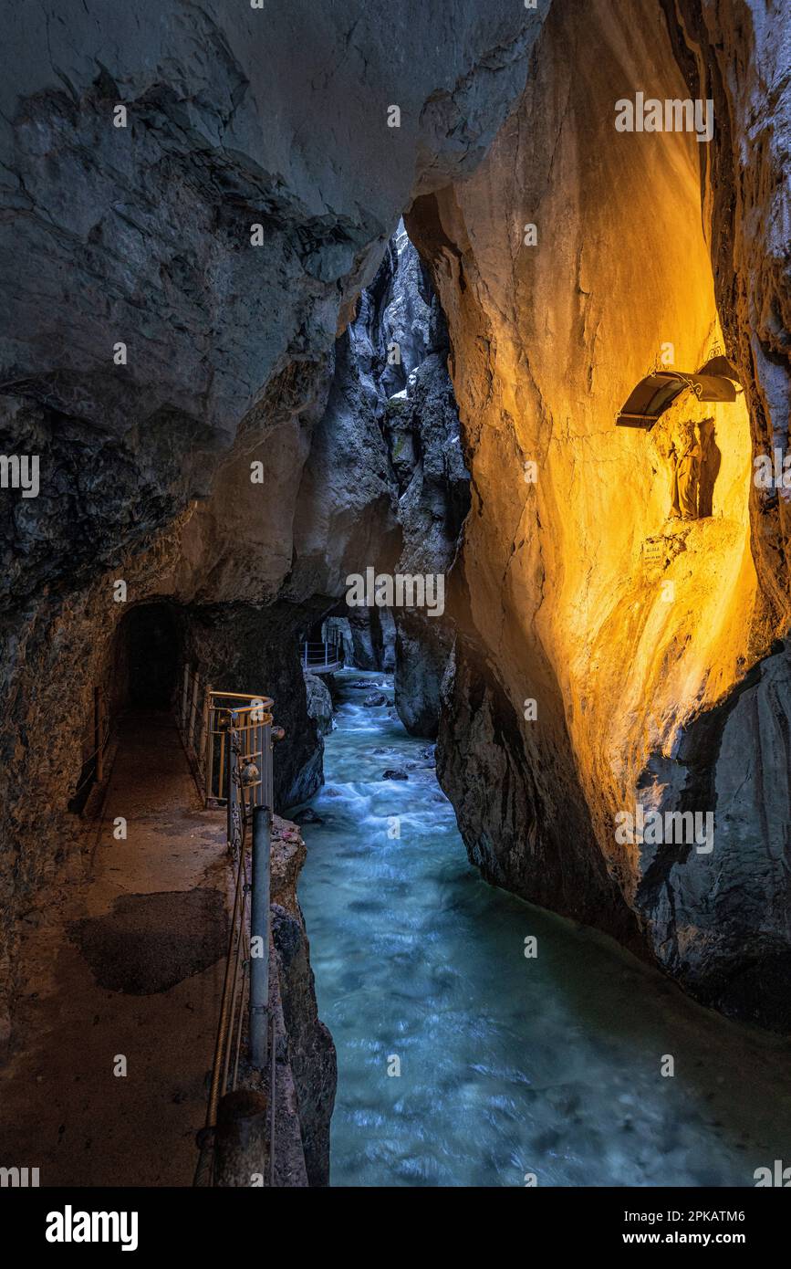 Illuminated statue of the virgin mary in partnachklamm gorge garmisch ...