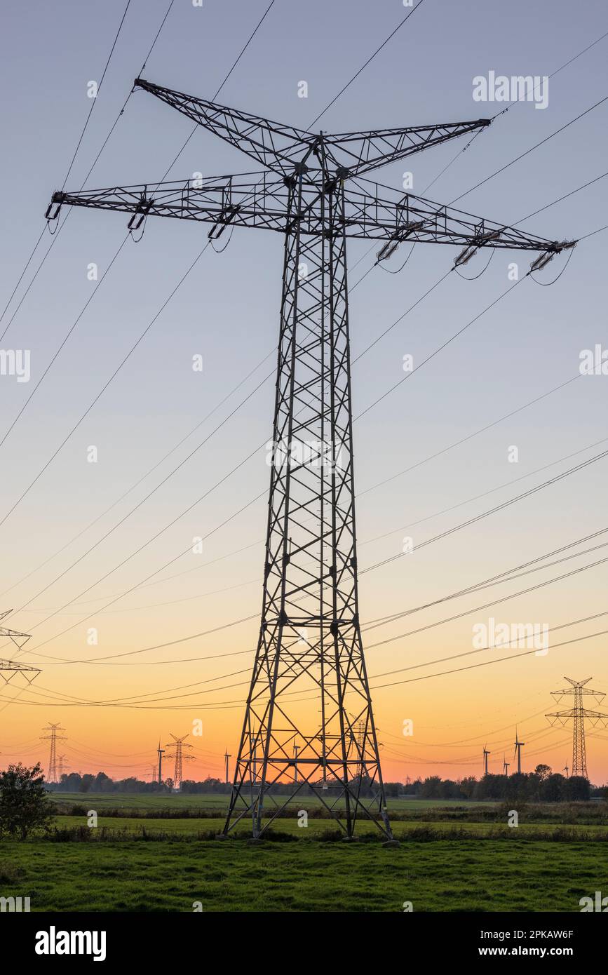 Overhead line, high voltage pylon, evening light, Schortens, in the ...