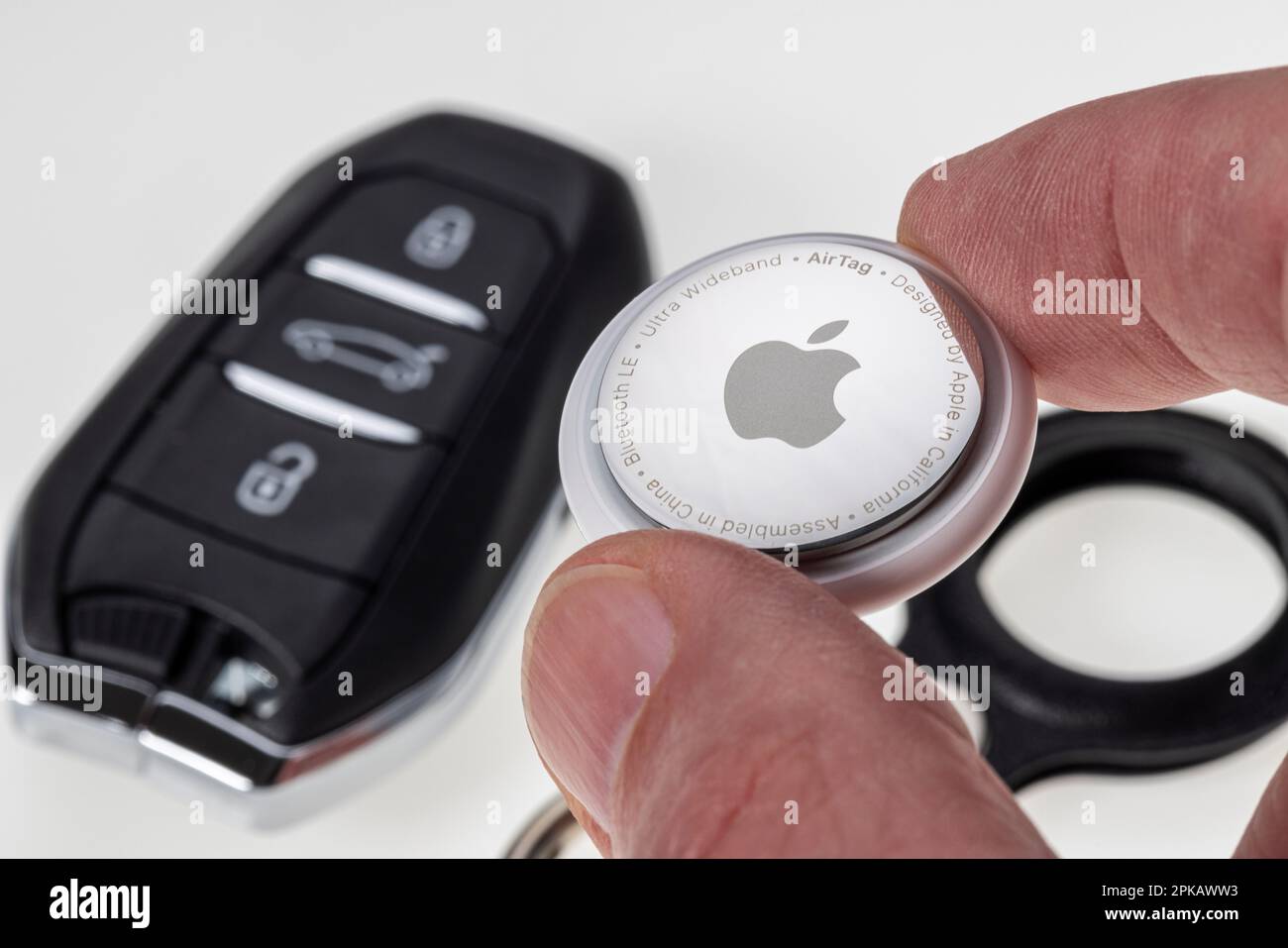 Man hand holding Apple AirTag, car key, key fob, detail, icon image ...