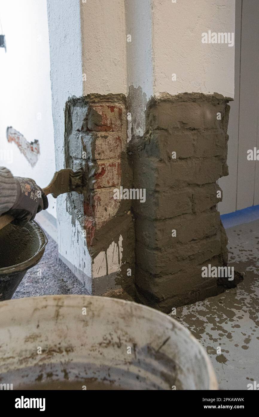 Masonry renovation in the basement area inside, applying the sealing ...