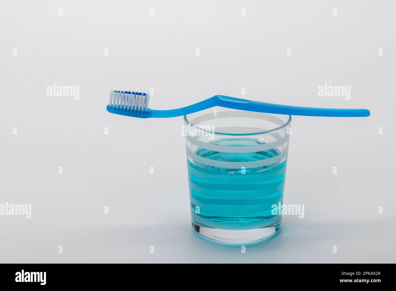 Toothbrush jar filled with mouthwash, manual toothbrush, symbol image ...