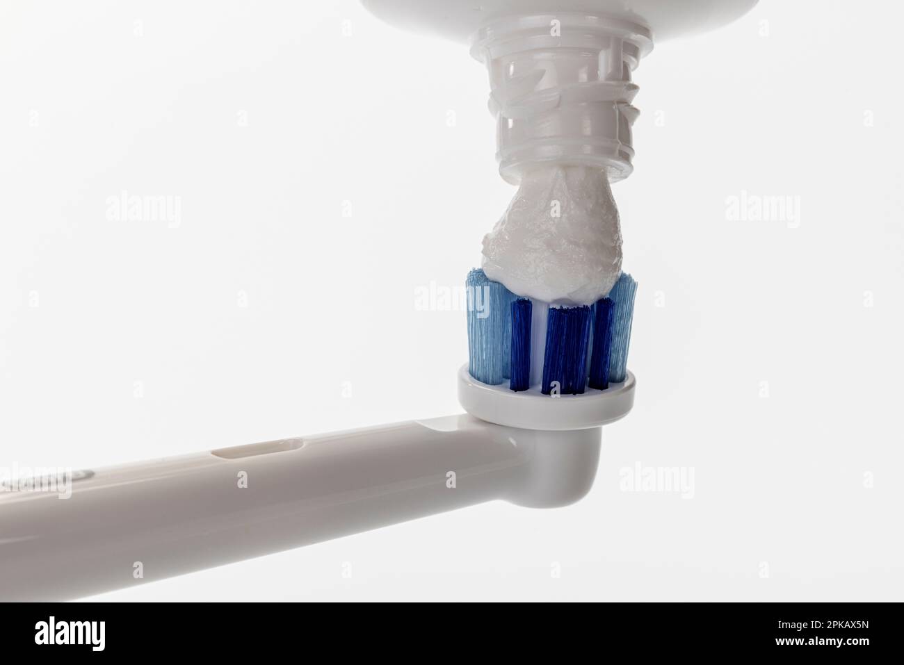 Toothpaste tube, toothpaste on toothbrush head of electric toothbrush ...