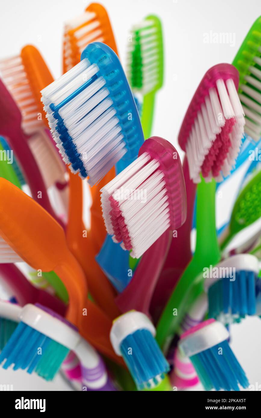 Many different colored toothbrushes in toothbrush cup, detail, symbol ...