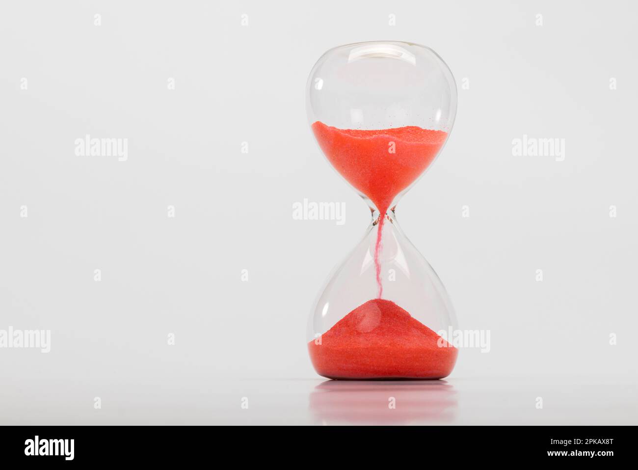 Hourglass, red, symbol image, transience, passage of time, white ...