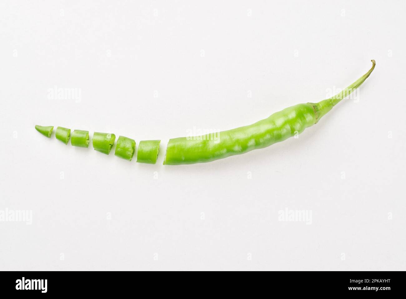 Top view of chopped green chilli on white background Stock Photo - Alamy