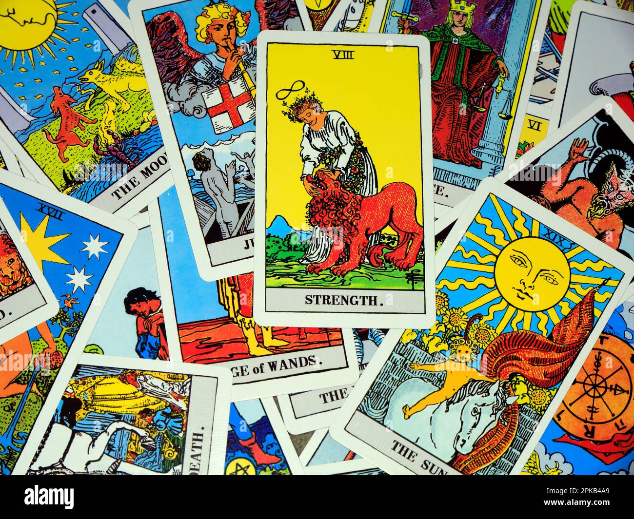 Tarot cards-scattered arrangement. Strength card prominent Stock Photo ...