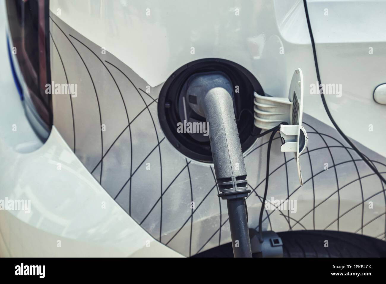 Electric car charging connect to electric car. Power cable pump plug in ...