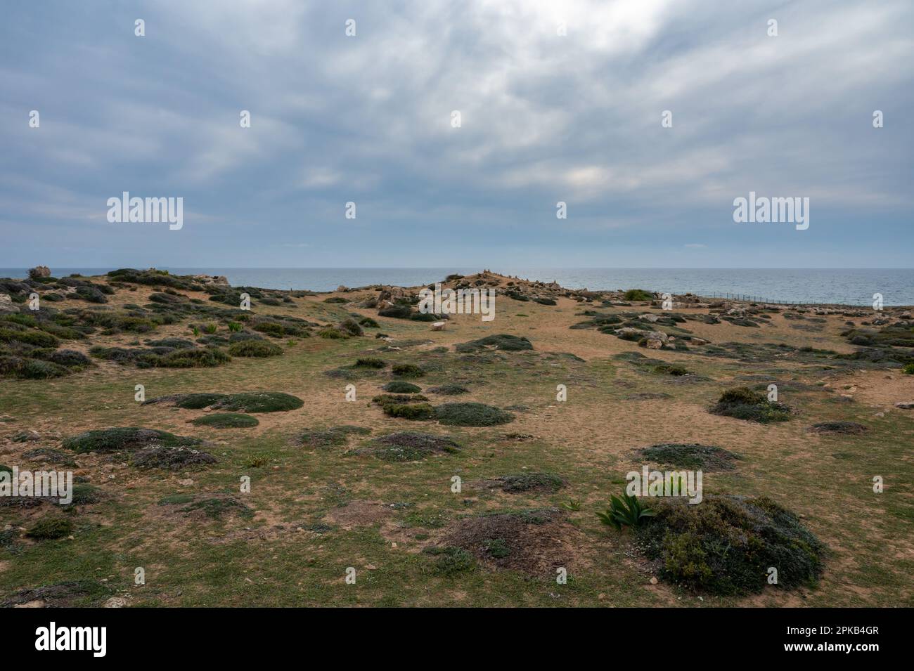 Scenic landscape view over the sand and rocks at the coast, Paphos ...