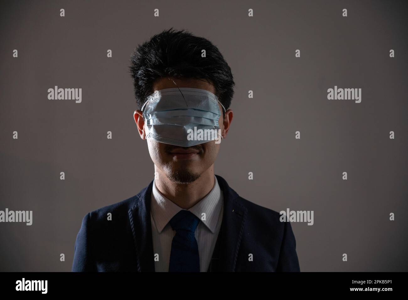 Man wearing a mask over his eyes Stock Photo - Alamy