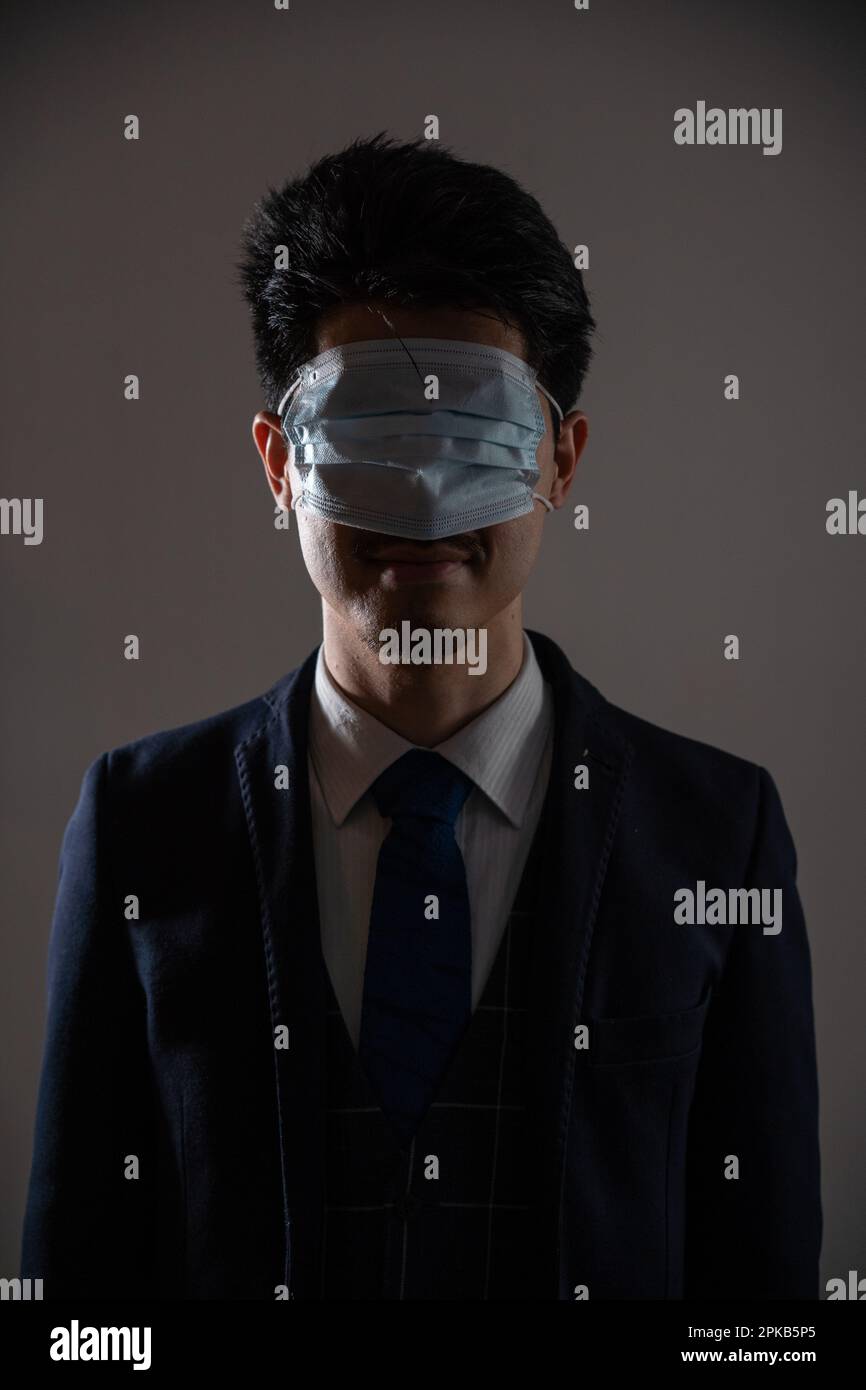 Man wearing a mask over his eyes Stock Photo - Alamy