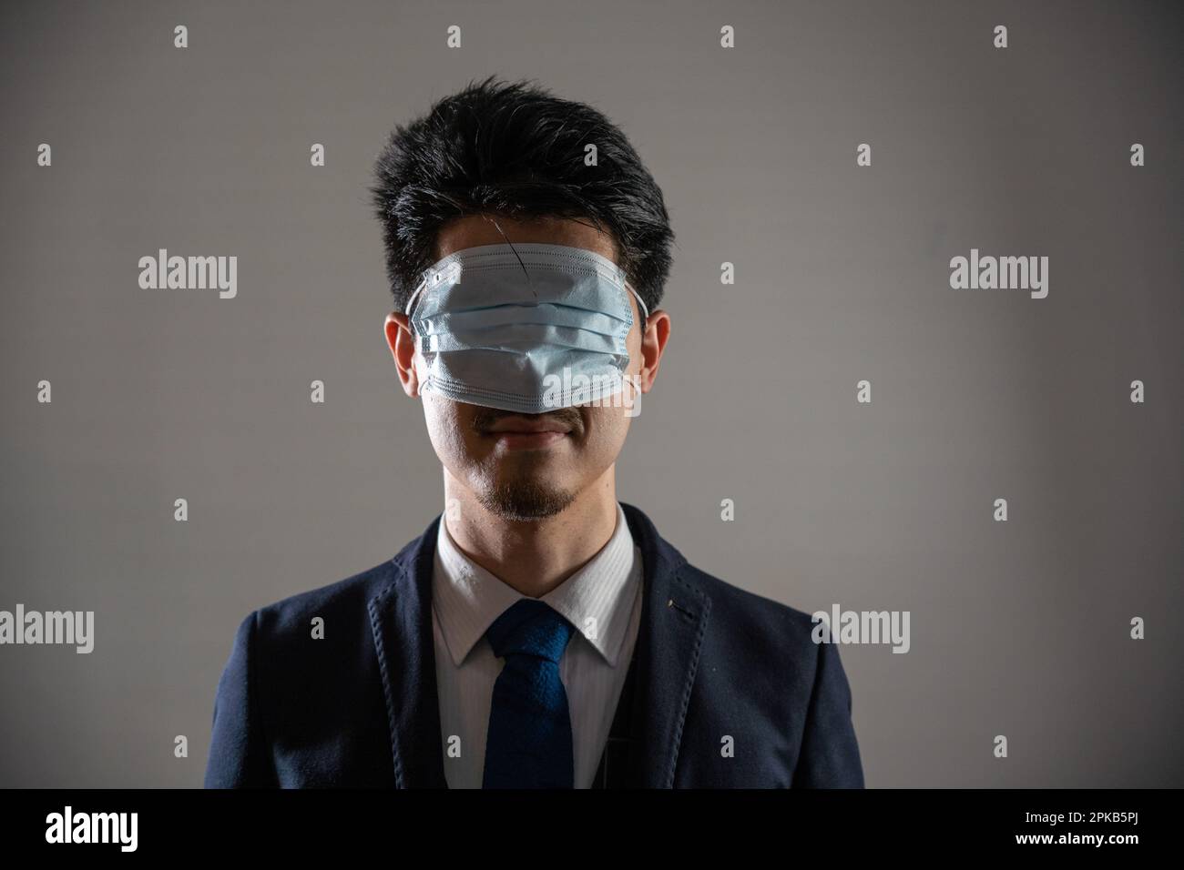 Man wearing a mask over his eyes Stock Photo - Alamy