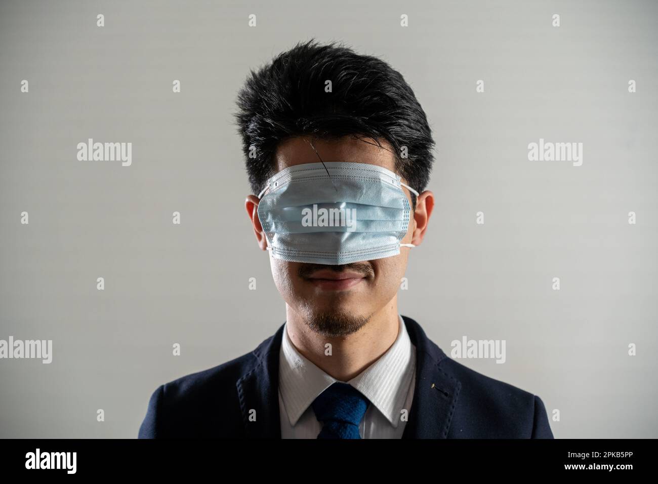 Man wearing a mask over his eyes Stock Photo - Alamy