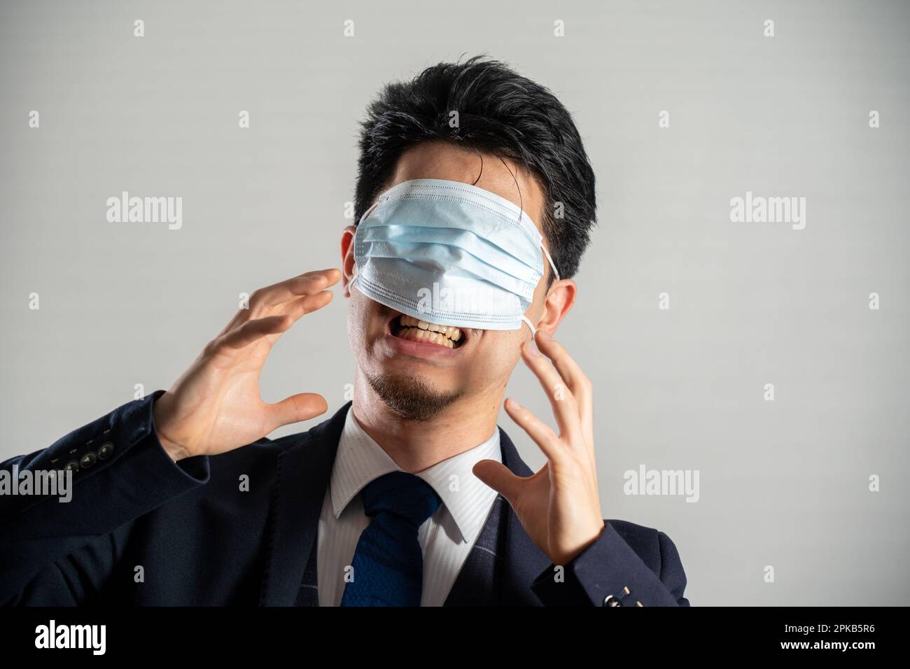 Screaming man wearing a mask over his eyes Stock Photo - Alamy