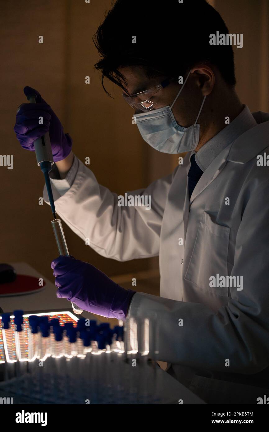 Male researcher in front of genome screens Stock Photo - Alamy