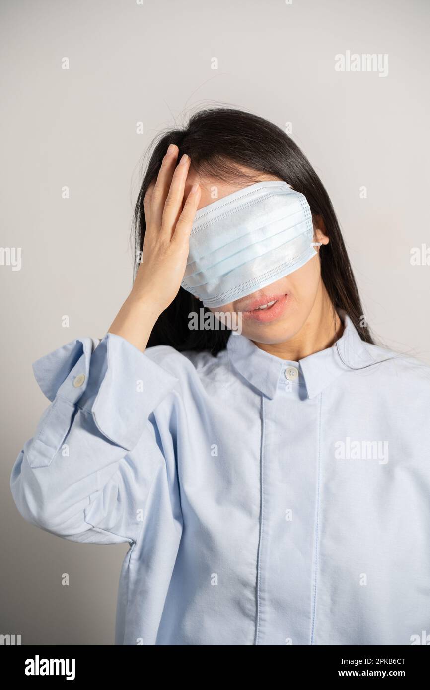 Young woman wearing a mask over her eyes Stock Photo - Alamy