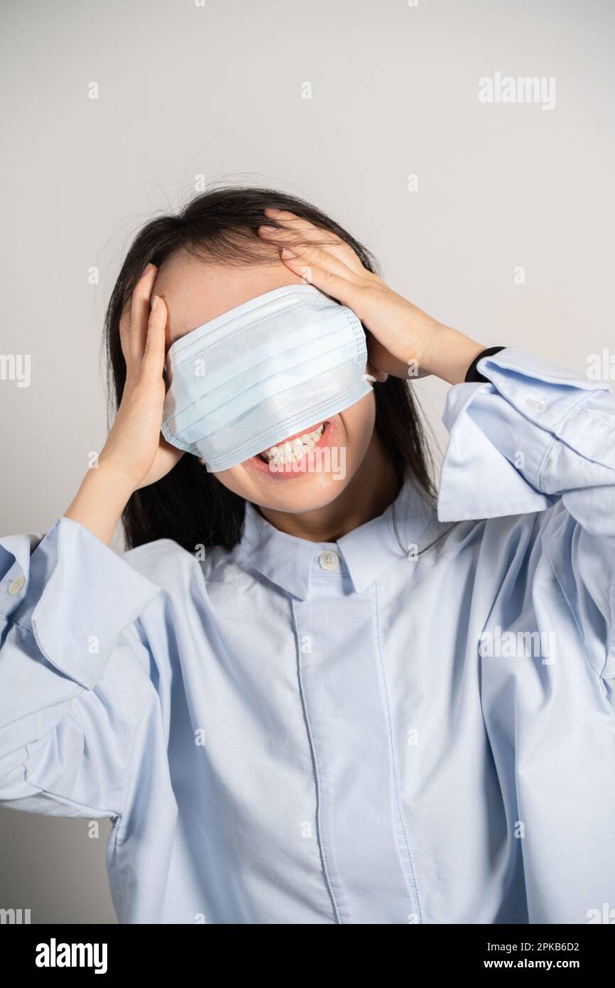 Young woman wearing a mask over her eyes Stock Photo - Alamy