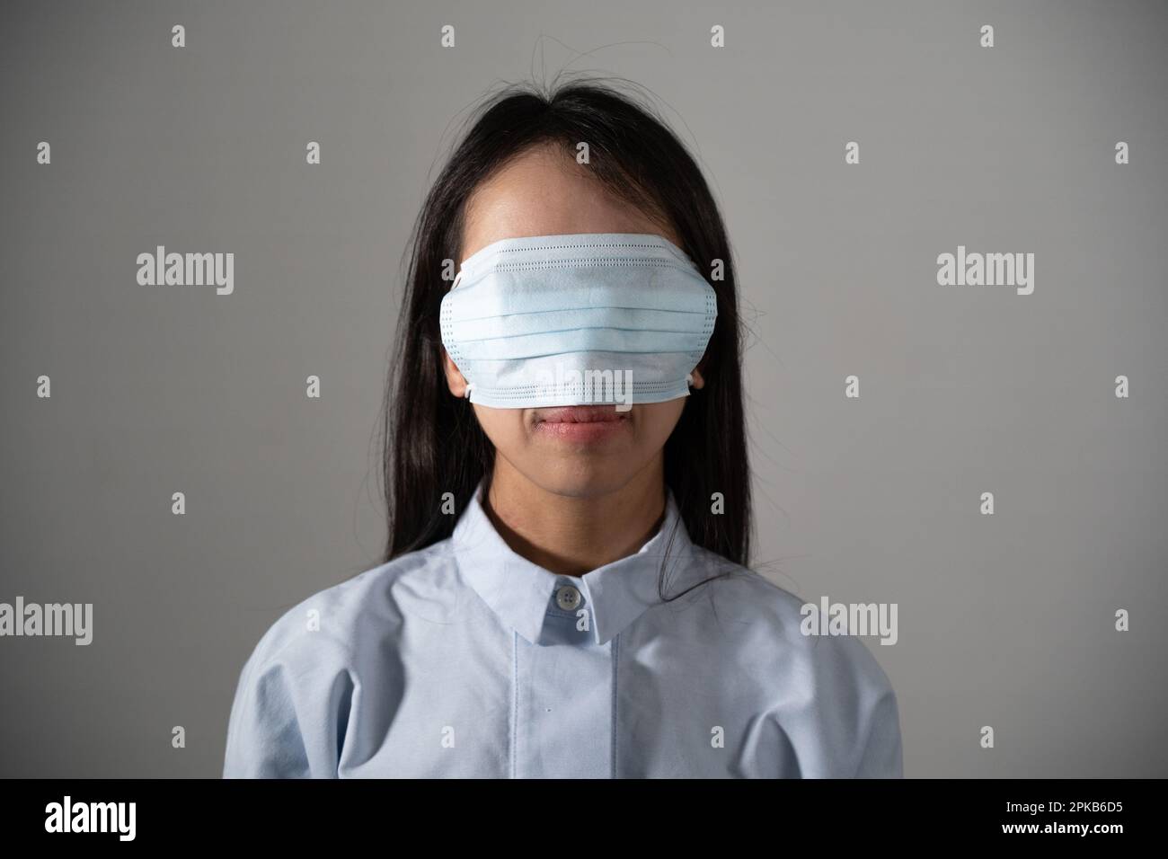 Young woman wearing a mask over her eyes Stock Photo - Alamy