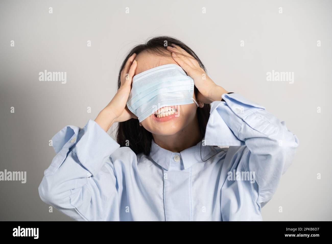 Young woman wearing a mask over her eyes Stock Photo - Alamy