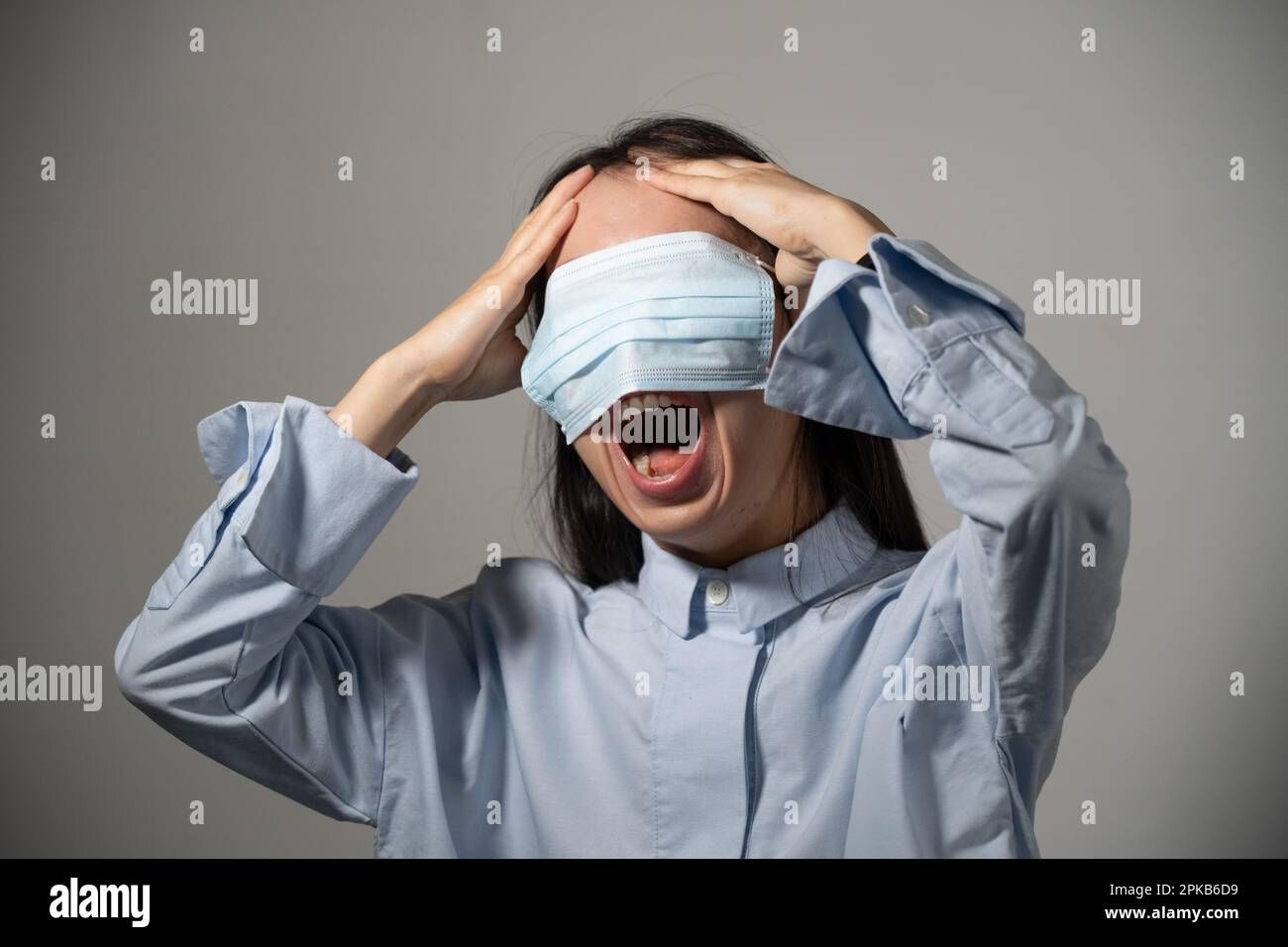 Young woman wearing a mask over her eyes Stock Photo - Alamy