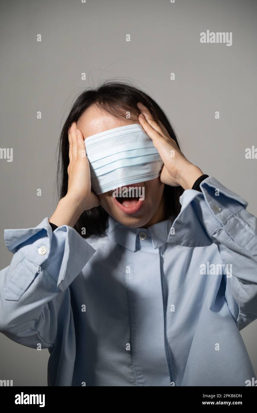 Young woman wearing a mask over her eyes Stock Photo - Alamy