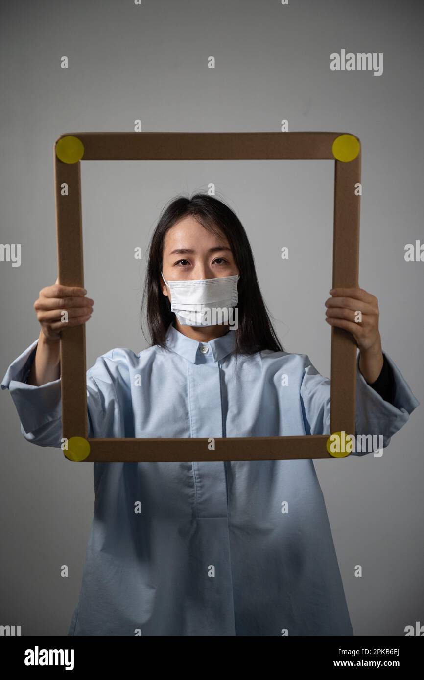 Masked and angry asian young woman Stock Photo - Alamy