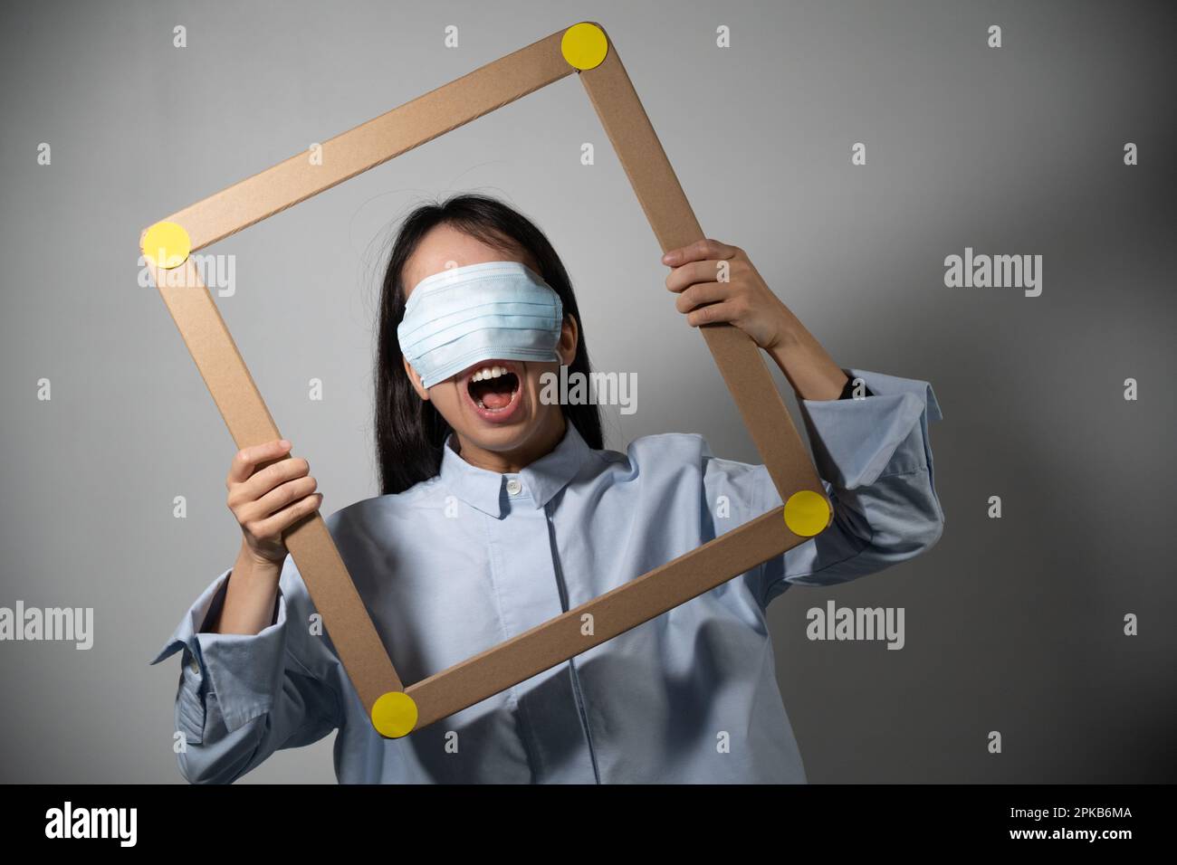 Masked and angry asian young woman Stock Photo - Alamy