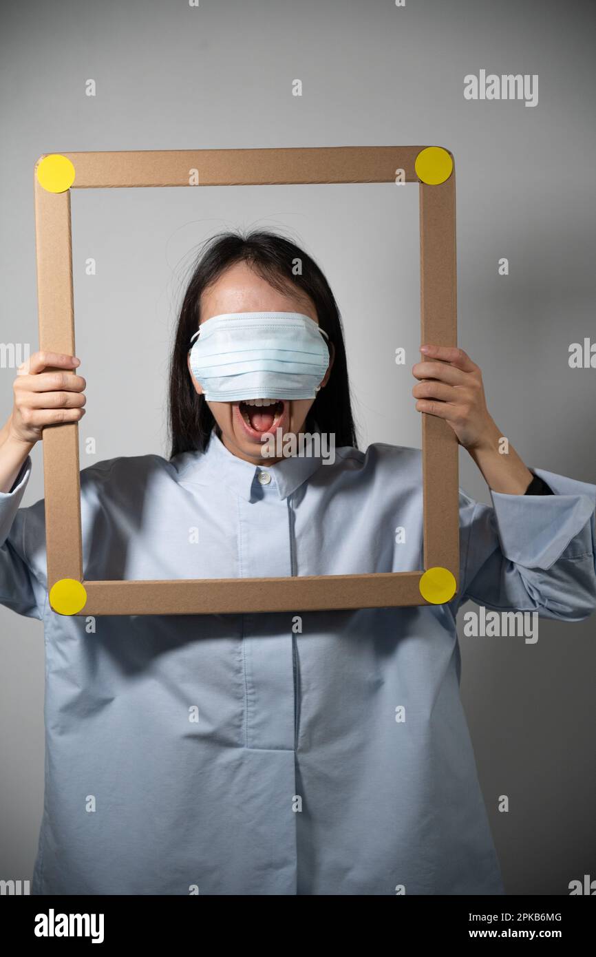 Masked and angry asian young woman Stock Photo - Alamy