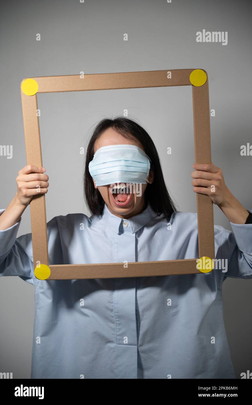 Masked and angry asian young woman Stock Photo - Alamy