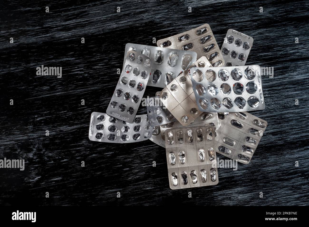 Empty blister packs of medicines, top view due to stained black ...