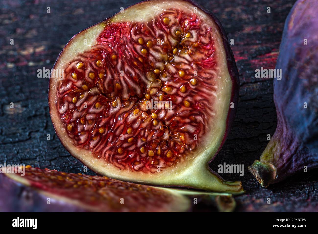 Black fig sliced in half ready to eat close-up top view on tone-on-tone ...