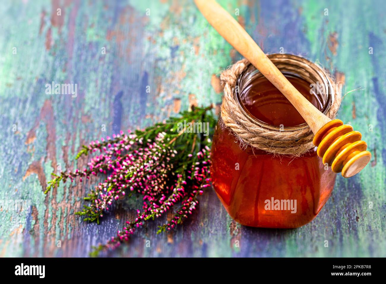 A saucer full of heather honey and a sprig of heather Stock Photo - Alamy
