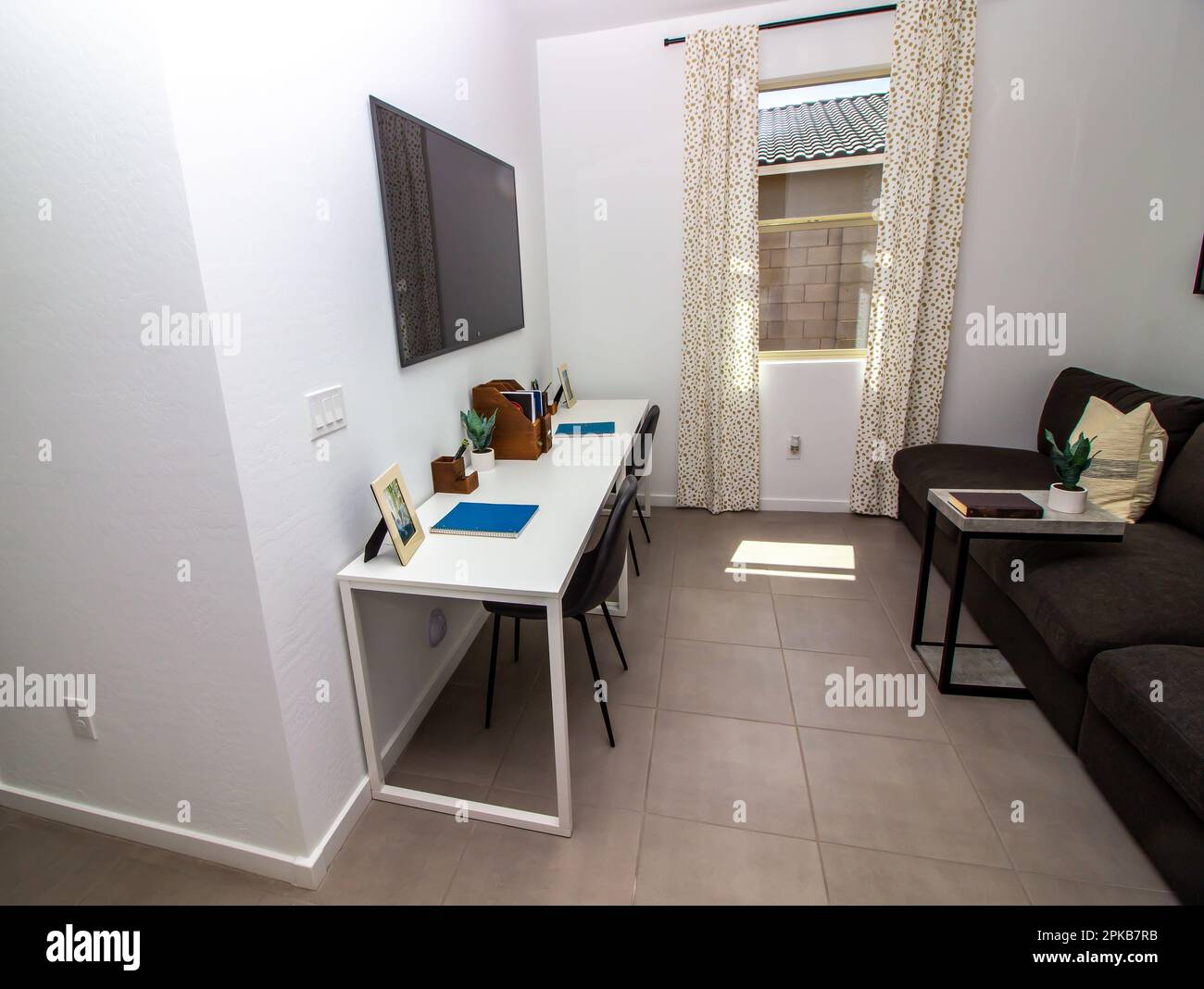 Work Desk In Home Den With Couch Stock Photo - Alamy